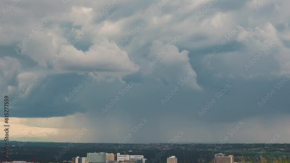 Huge dark hurricane stormy clouds gettering above a city, panoramic view of storm cloudscape at ...