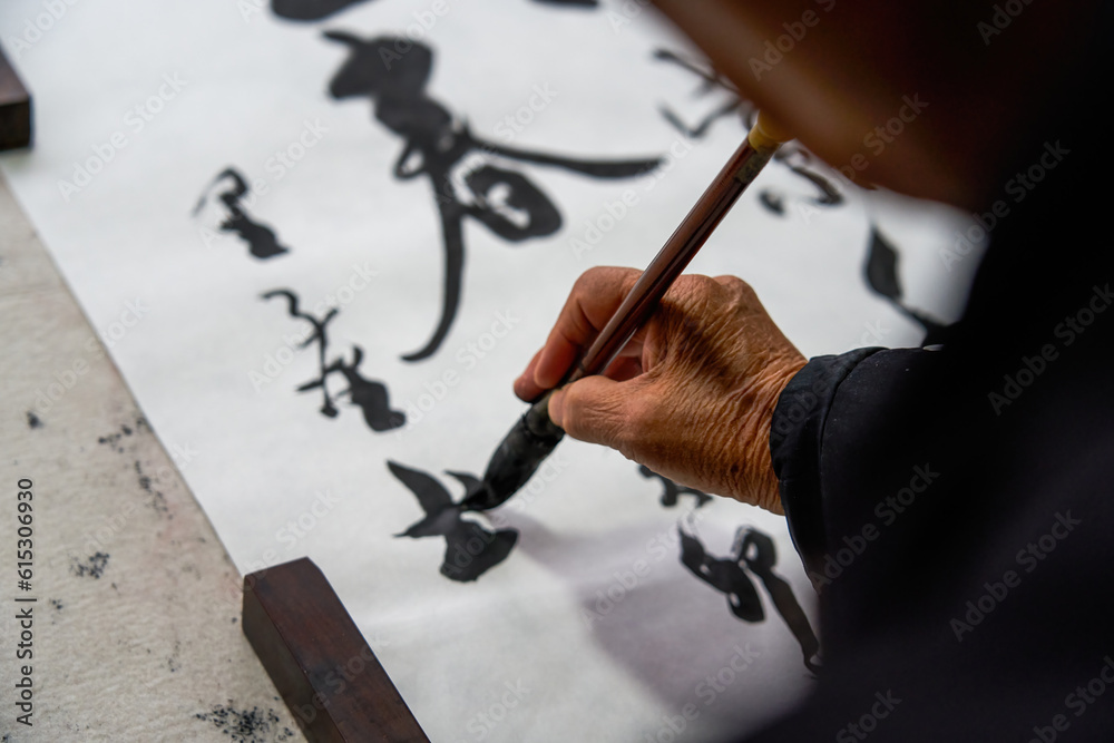 Poster Print An old Chinese calligrapher is writing brush characters creating Chinese calligraphy works 40x26.7 cm
