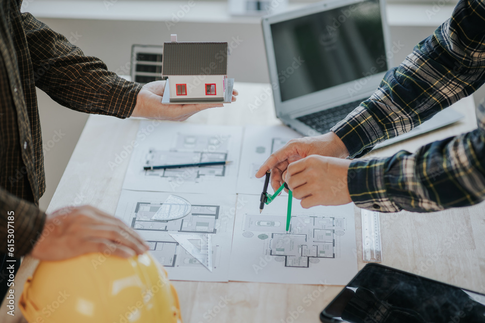 Engineer working in office at desk with solar laptop and concept home ...