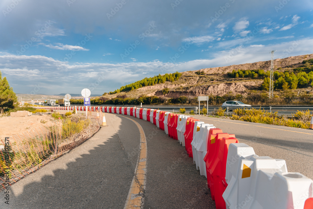 Road works sign on the road. Repair work of road signs and a bypass ...