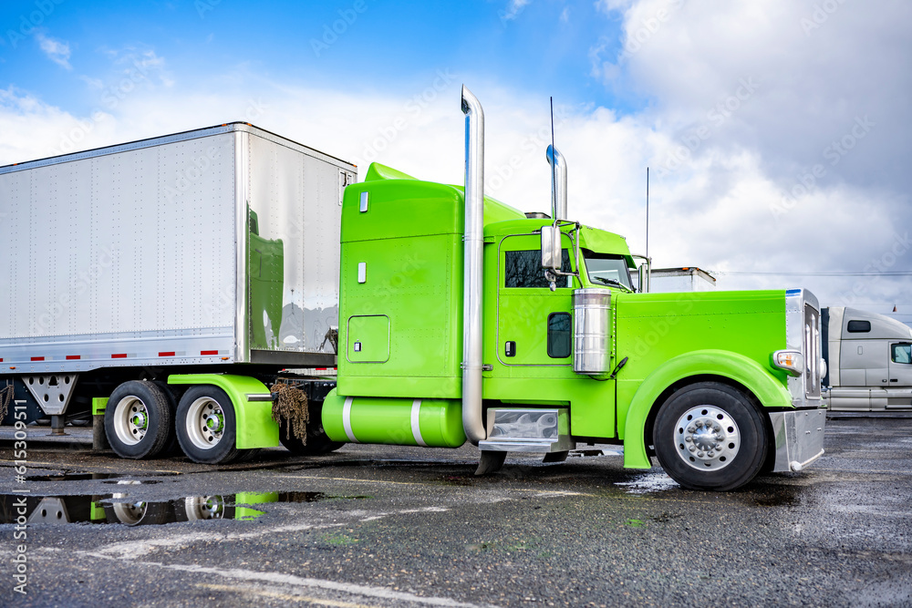 Clean bright green big rig American classic semi truck with dry van ...