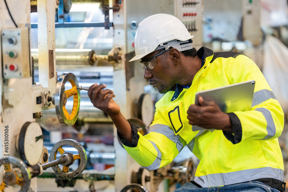 african engineer Wear uniforms and helmets. Work control via tablet ...