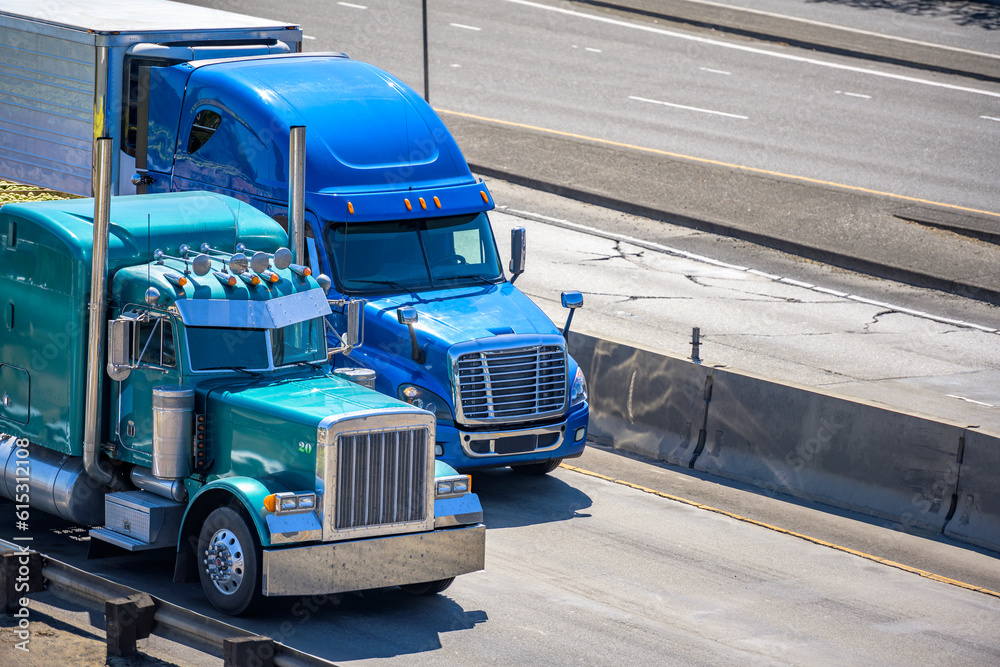 Two big rig semi trucks classic and new styles with flat bed and ...