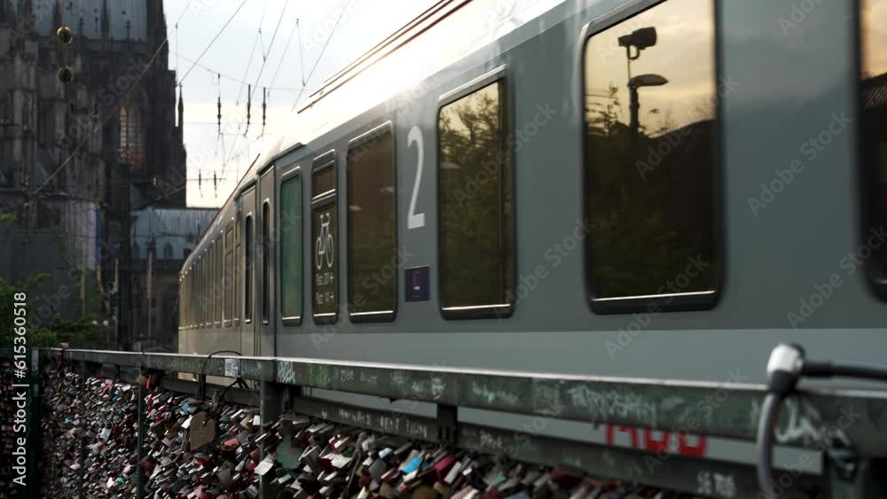 Regional Train Going Past Railing With Padlocks During Golden Hour In ...