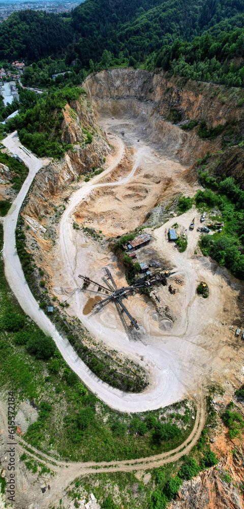 Aerial vertical shot of an industrial limestone quarry on a hill ...