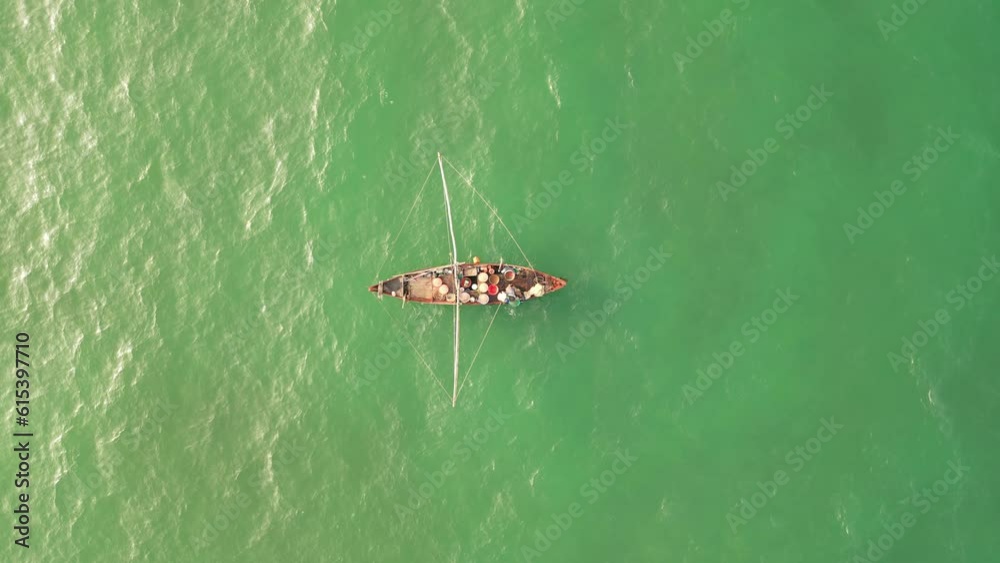 Aerial view of small fishing boat in the ocean. Top view of sailing ...