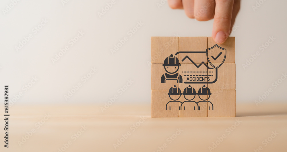 Zero accident and work safety concept. Placing wooden cube with icon of ...