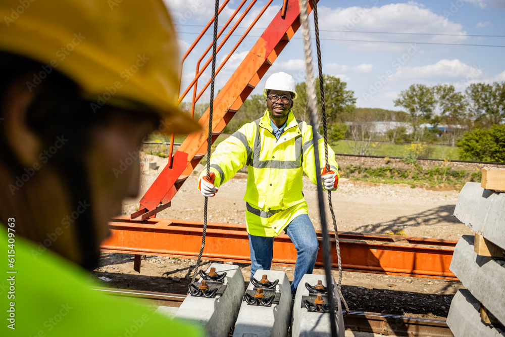 Railroad construction. Workers placing railroad ties and building new ...