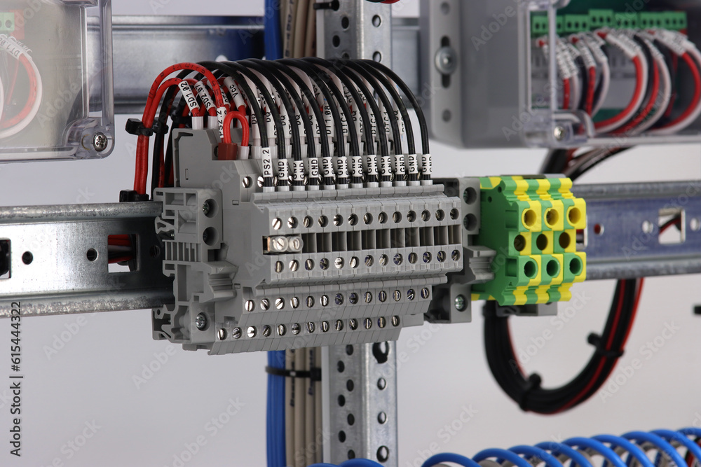 Electrical terminals with connected mounting wires are installed in an ...