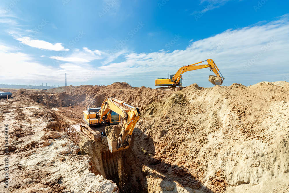 Two Excavator are digging soil in the construction site on sky ...