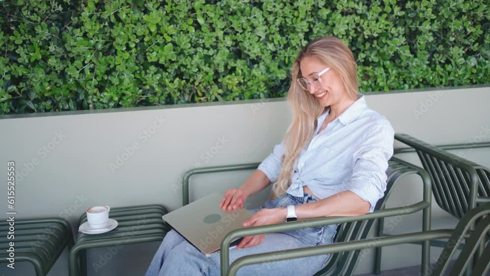 Woman freelancer open laptop sitting on cafe terrace. Female freelance ...