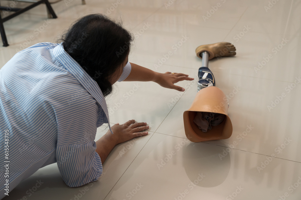 Amputated woman falling down to the floor and trying to catching ...