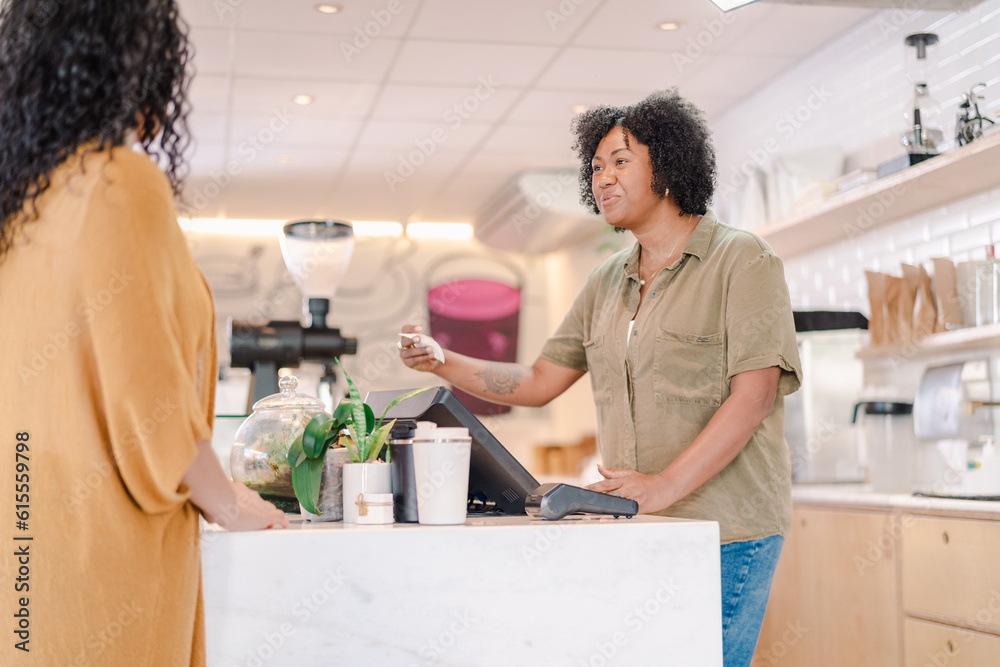 atendente Brasileira entregando a conta para a cliente em uma cafeteria ...
