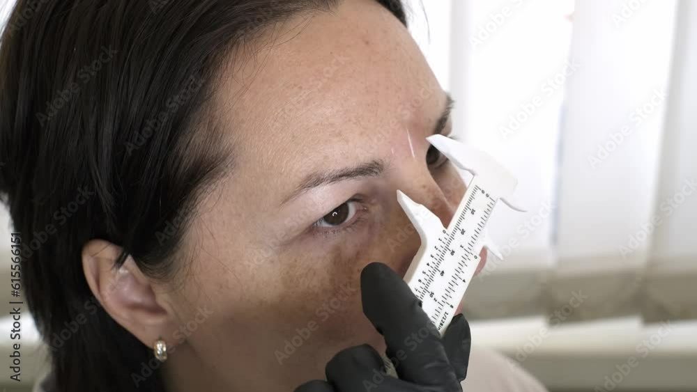 Eyebrow Reshaping in Action: Using a ruler for precision, the stylist ...