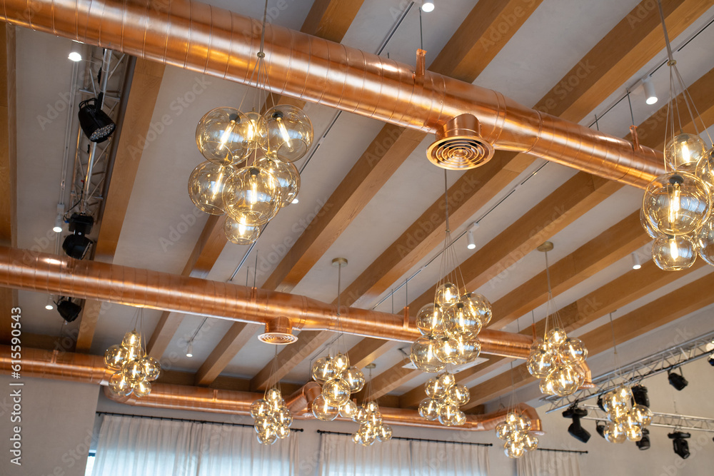 Ventilation system copper color, open type. Ceiling in a modern loft ...