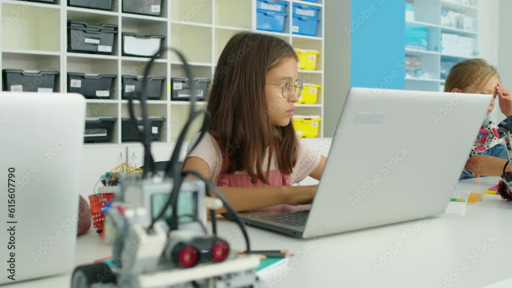 Chest-up shot of geeky preteen Caucasian girl in glasses sitting at ...