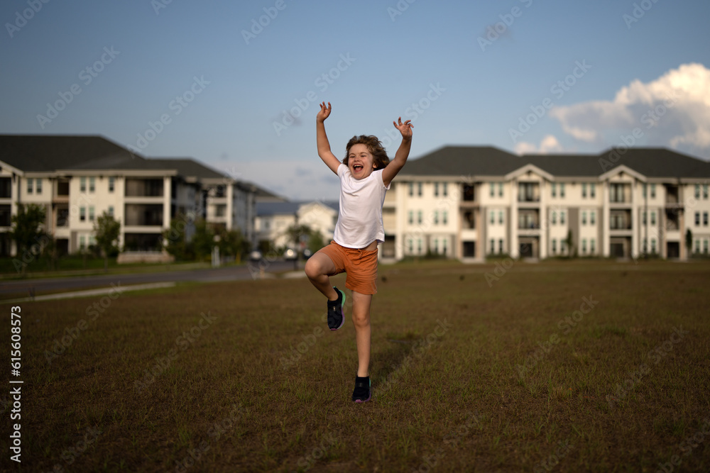 Excited kid boy running on green grass background, panoramic banner ...