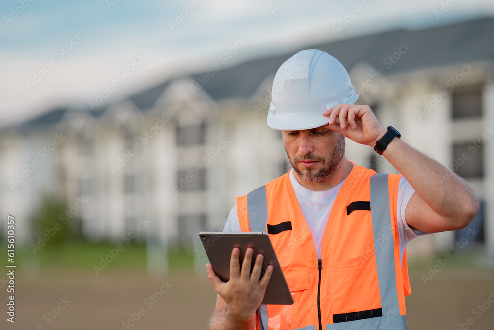Engineer with tablet, building inspection. Construction man in helmet ...