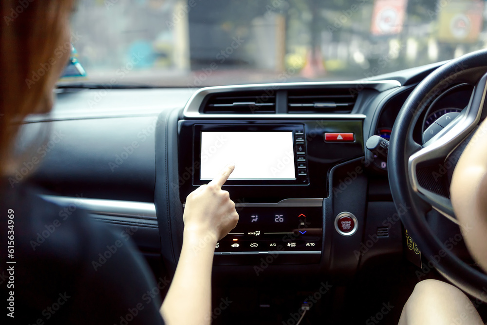 Women hand touching a multimedia system with an isolated screen in car ...