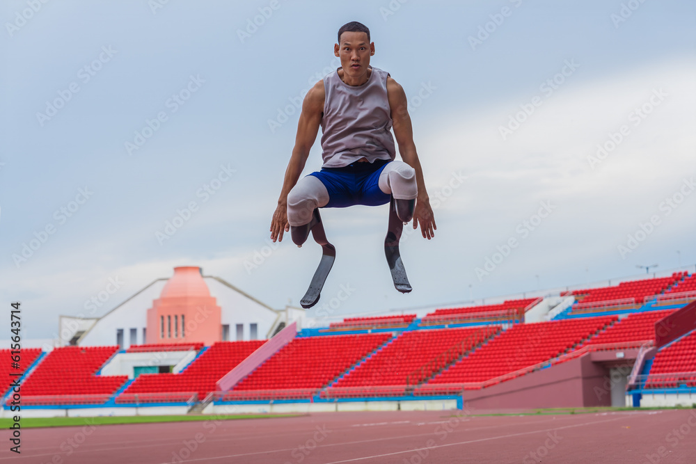 Victorious Asian speed runner, sporting two prosthetic running blades ...