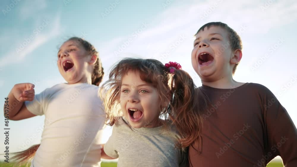 Video Stock group of kids team hugging a jumping and rejoicing outdoors ...