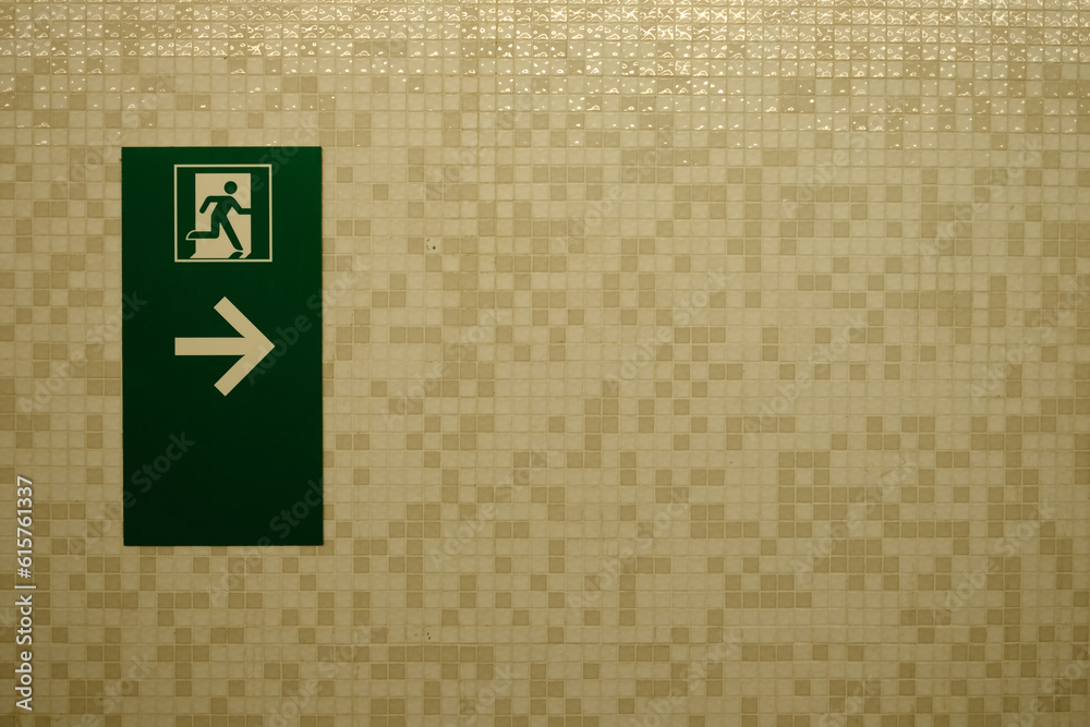 Fire Exit Sign on Tiles Wall Background. Stock Photo | Adobe Stock