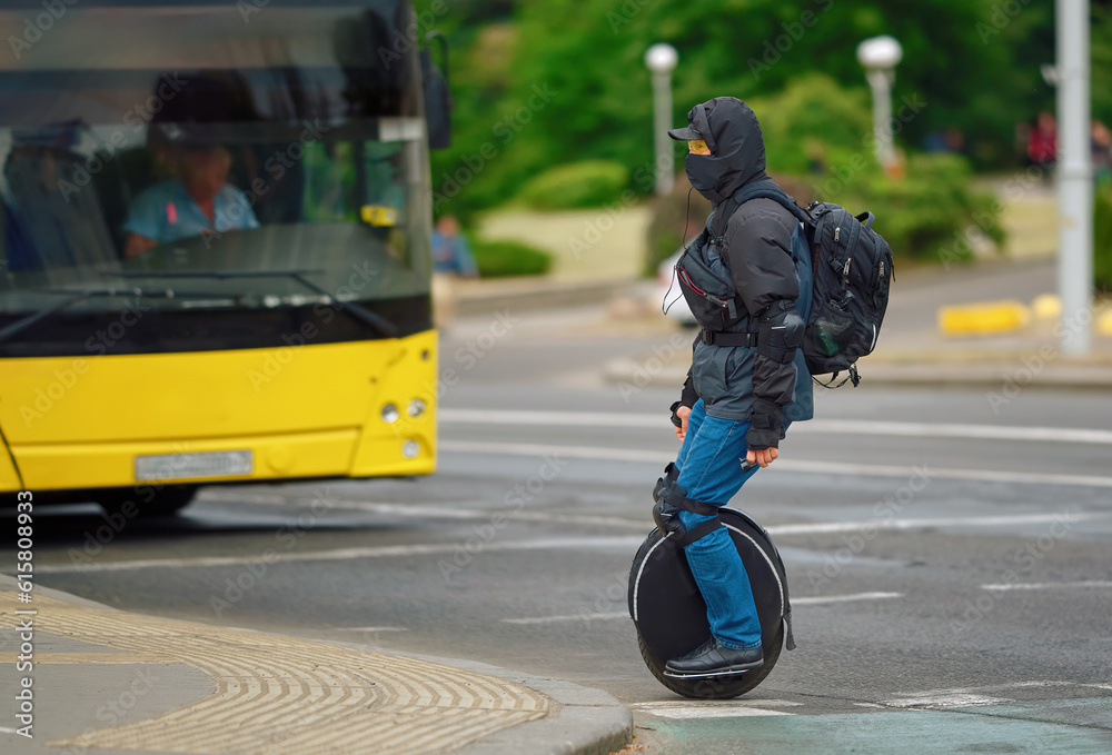 Man riding on unicycle, driving single wheel. Unrecognizable man ...