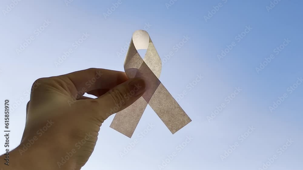 White ribbon as a symbol of peace against the blue sky. World Day of ...