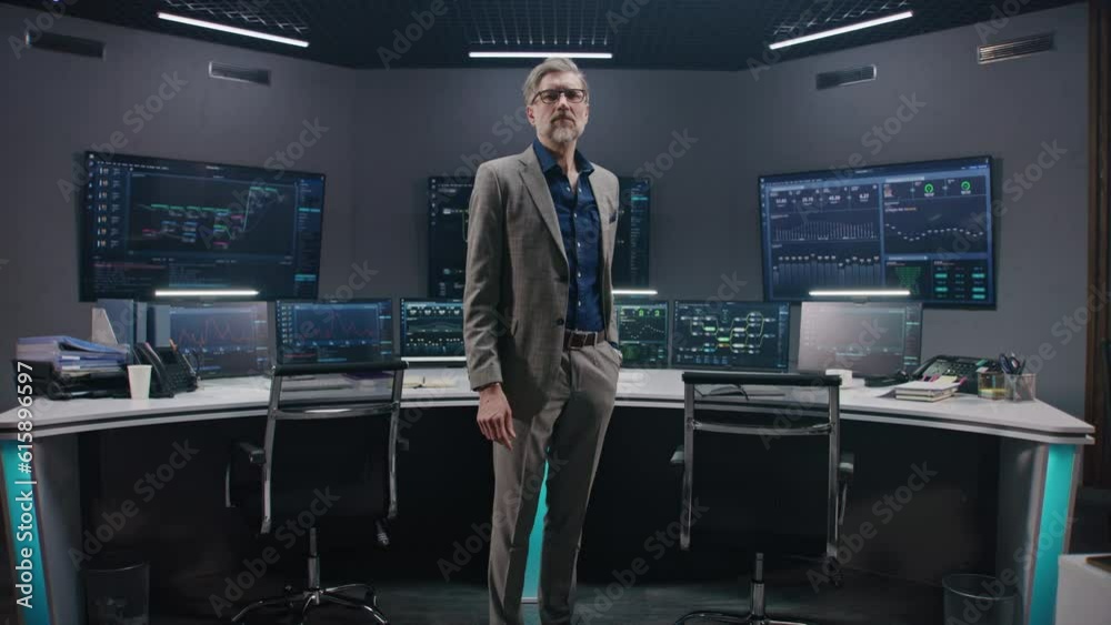 Big data scientist in business suit puts on glasses, stands in ...