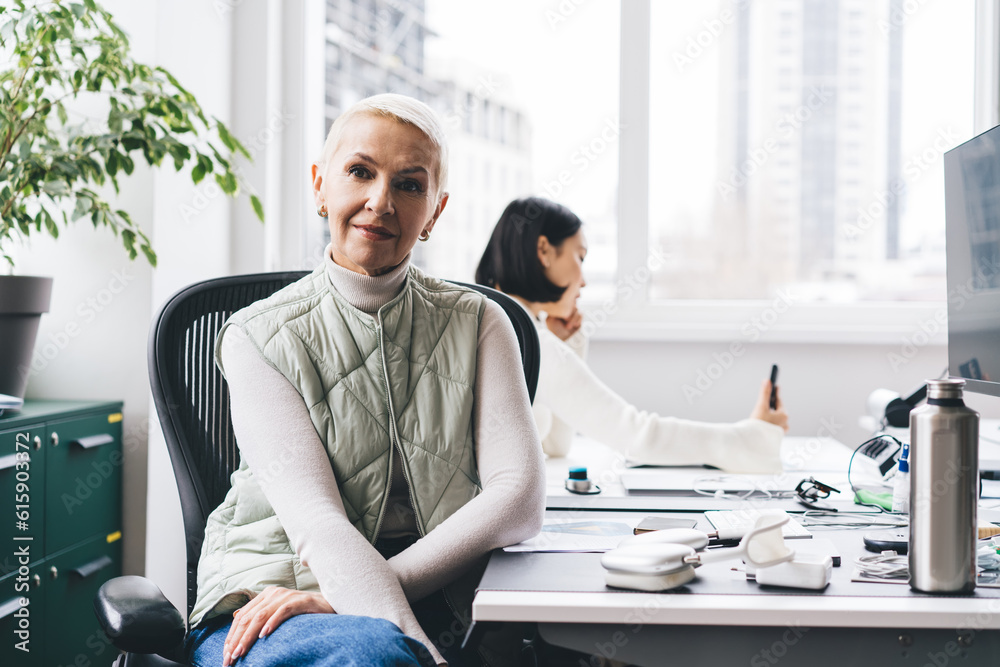 Portrait of Caucasian businesswoman dressed in casual clothes looking ...