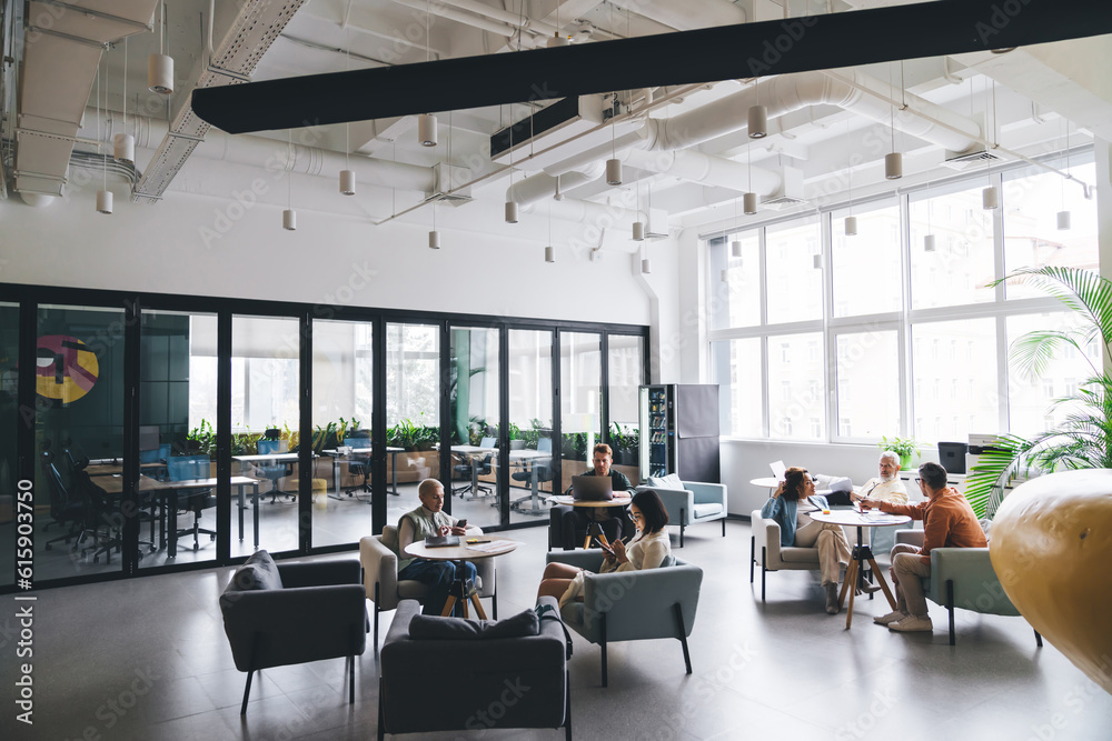 Group of coworkers in spacious workplace Stock Photo | Adobe Stock