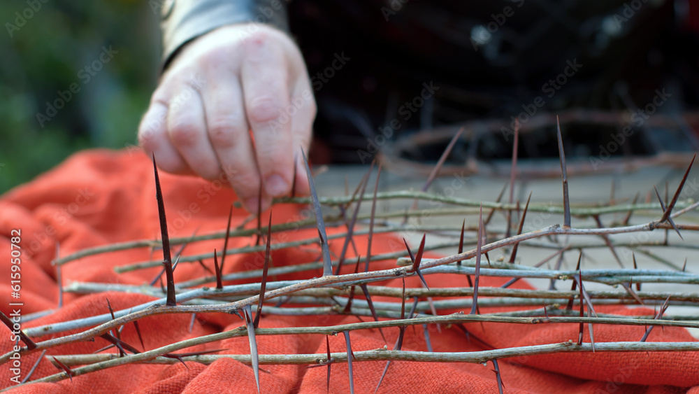 Symbolic image with the hand of a roman soldier making a crown of ...