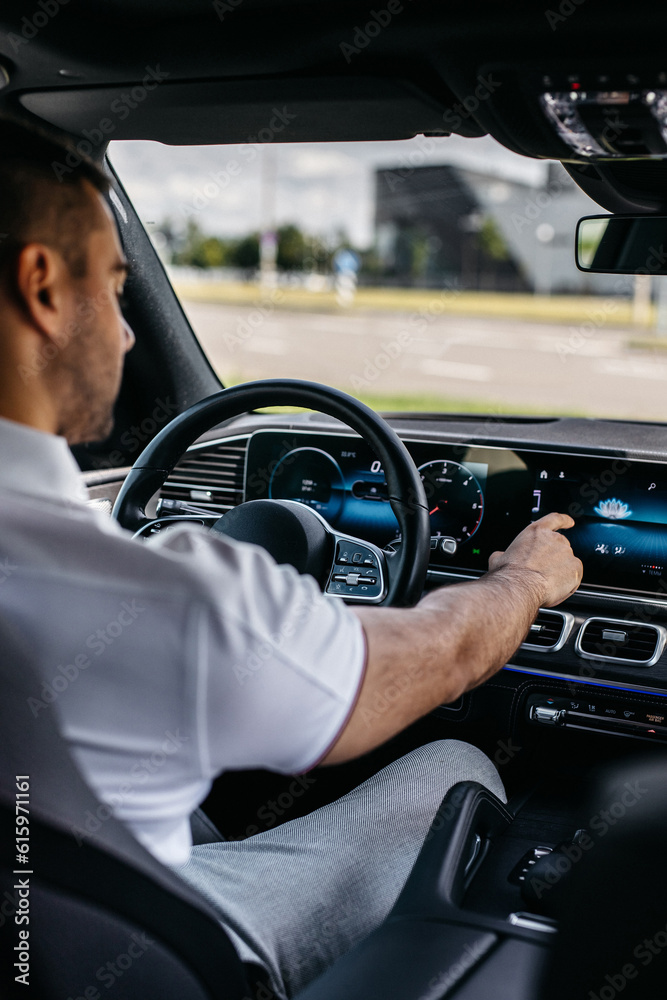 Getting around the city. Rear view of young man using navigation system ...