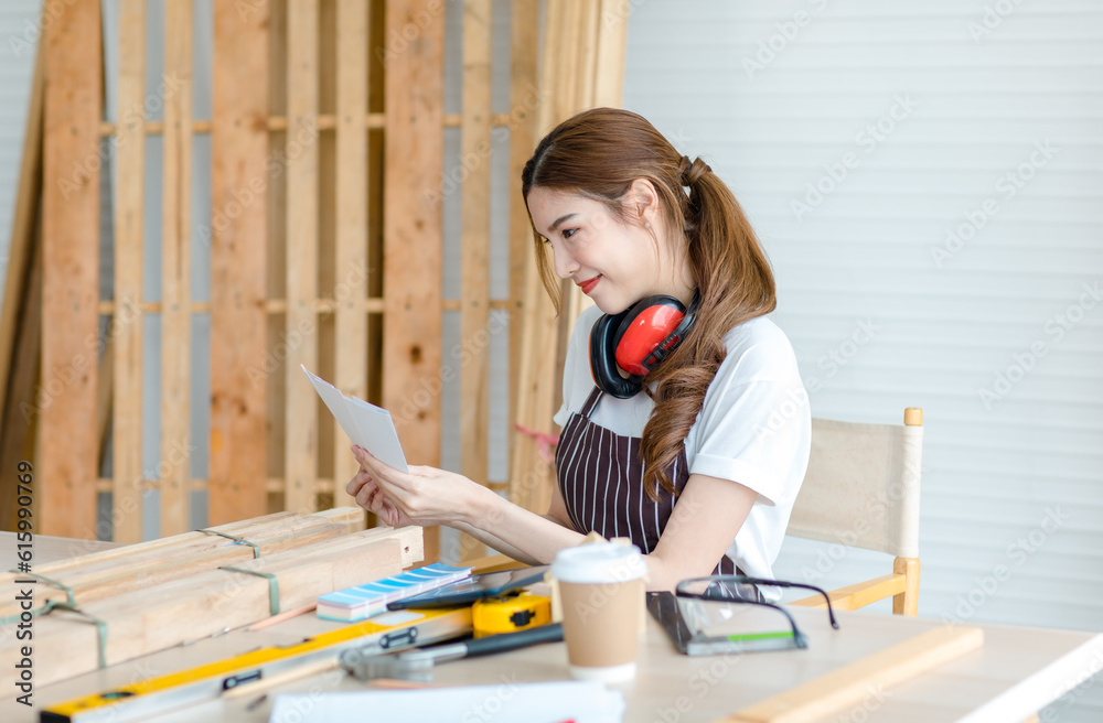 Asian professional cheerful female carpenter worker staff in apron with ...