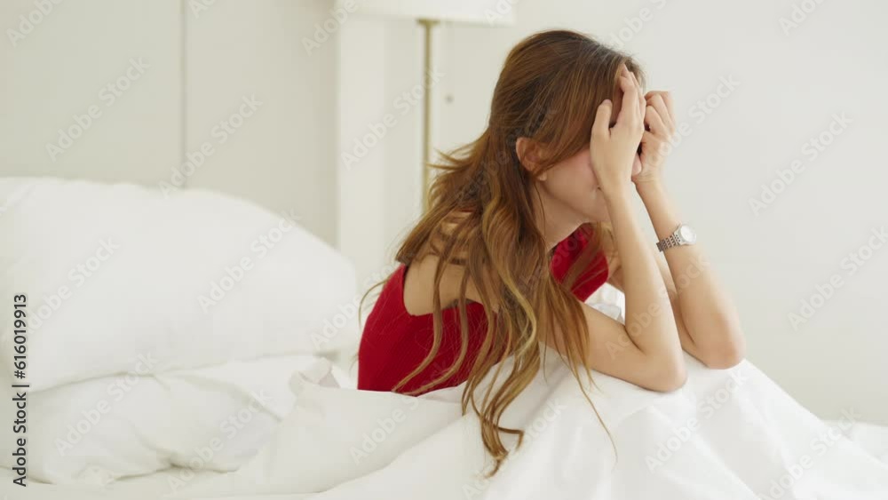 4K Sadness Asian woman sitting on the bed in bedroom with feeling ...