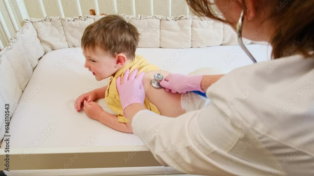 The doctor instructed the boy to take deep breaths while he listened to ...