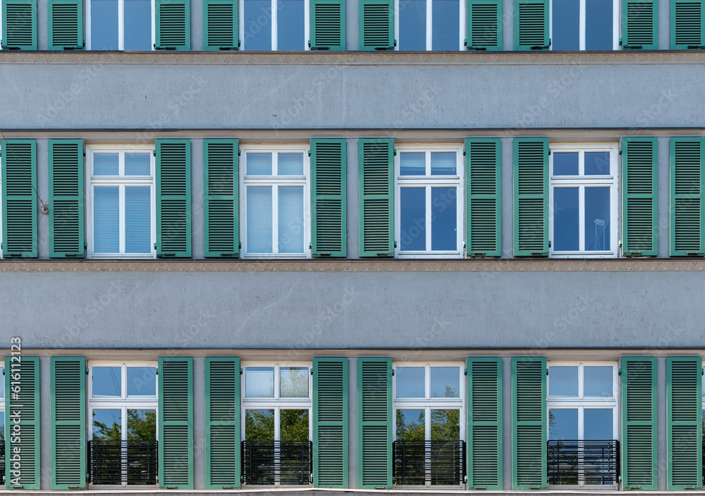 windows with green facade Stock Photo | Adobe Stock