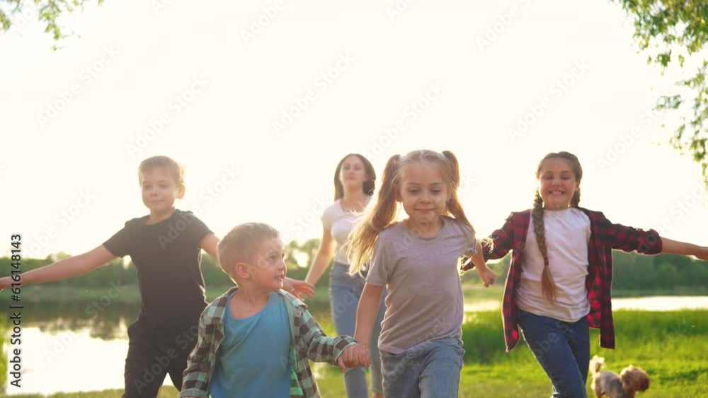 children run in the park. happy family. a group of children run in ...