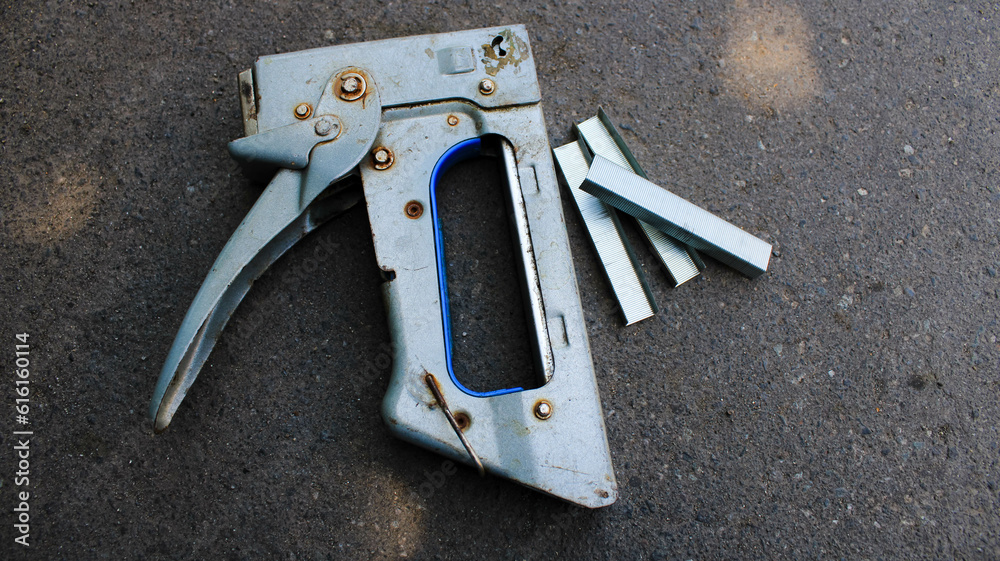 old stapler gun on asphalt background, hand powered stapler Stock Photo ...