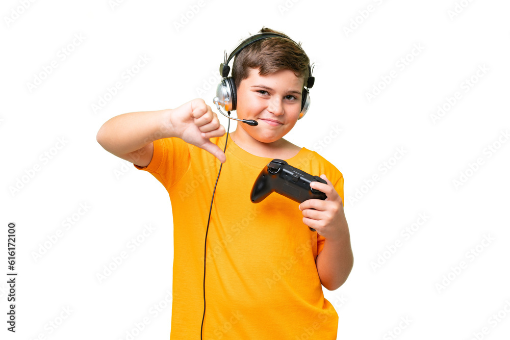 Little caucasian kid playing with a video game controller over isolated ...