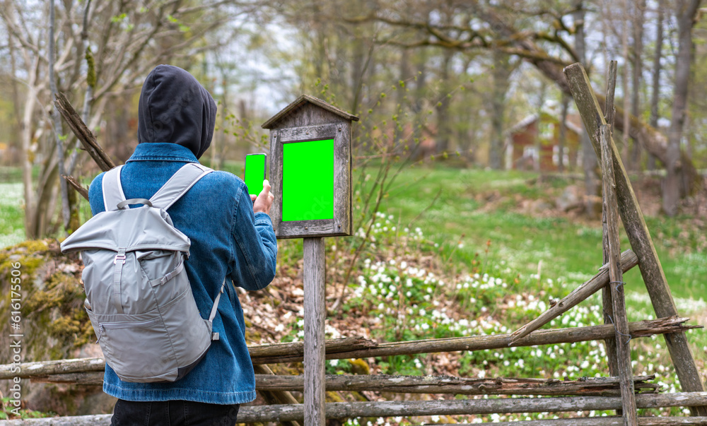 Tourist with backpack search mobile smart phone for information on ...