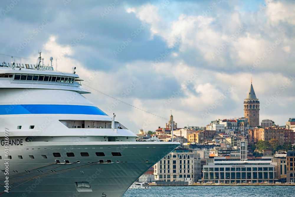 Cruise liner Astoria Grande at Port Bosphorus. Defocused Galata tower ...