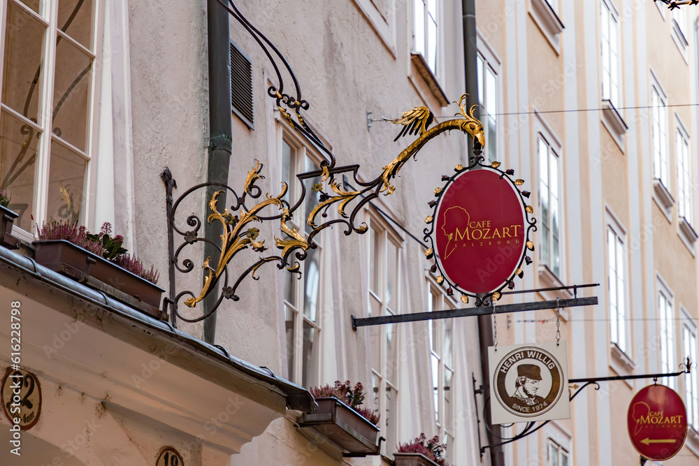 Typical ornate signage hanging on the exterior walls of old town ...