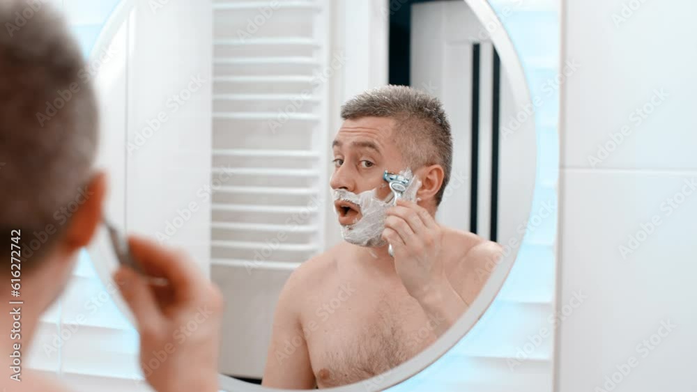 Razor shaving man face. Caucasian man shaving face with shaver. Cut ...