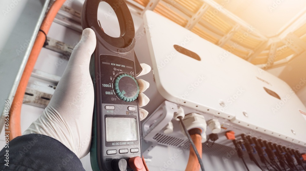 Checking and measuring power cable lines in solar panel. With shiny ...