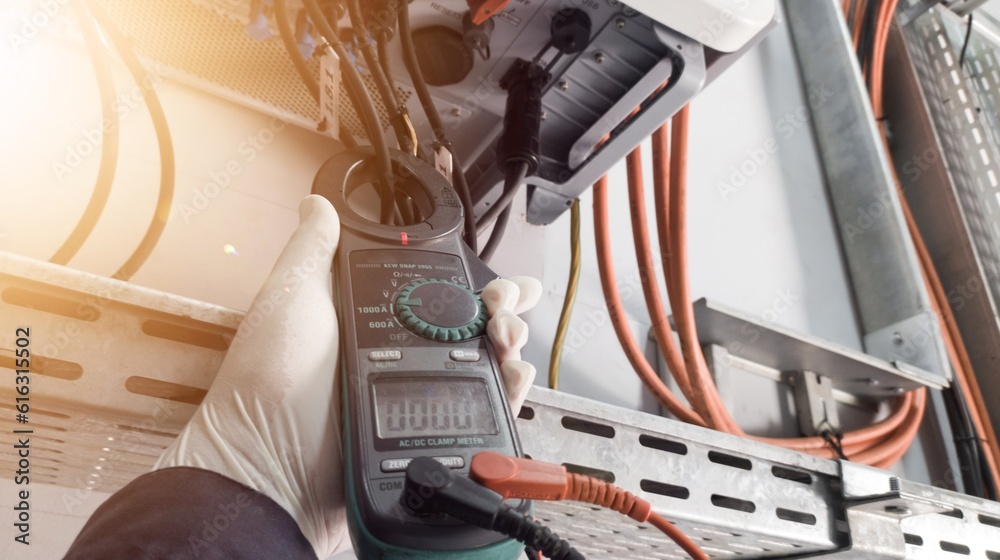 Checking and measuring power cable lines in solar panel. With shiny ...