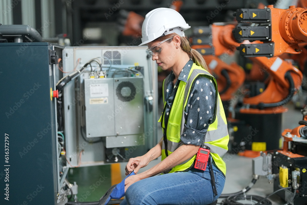 Robotic Arm engineer check on equipment in its with software of an ...
