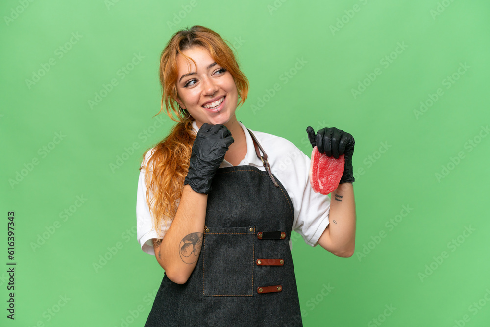 Butcher caucasian woman wearing an apron and serving fresh cut meat ...