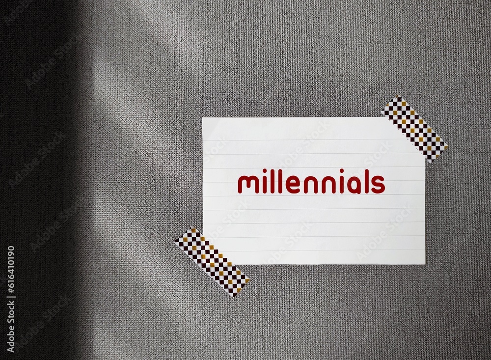 Stick note on gray office wall with text written Millennials - means ...