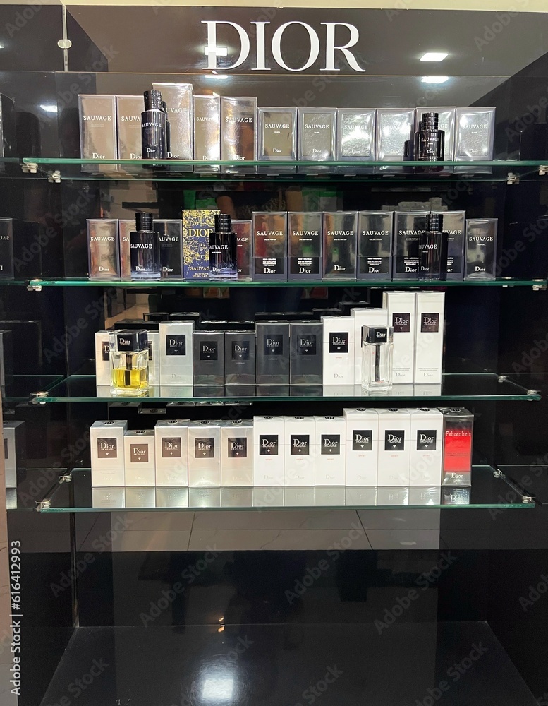 Shelf with luxury perfumes brand Dior. Branded rack in store, shopping ...
